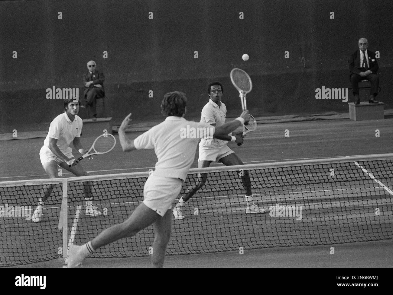 Arthur Ashe of Richmond, Va., right, gets ready to return the ball hit ...