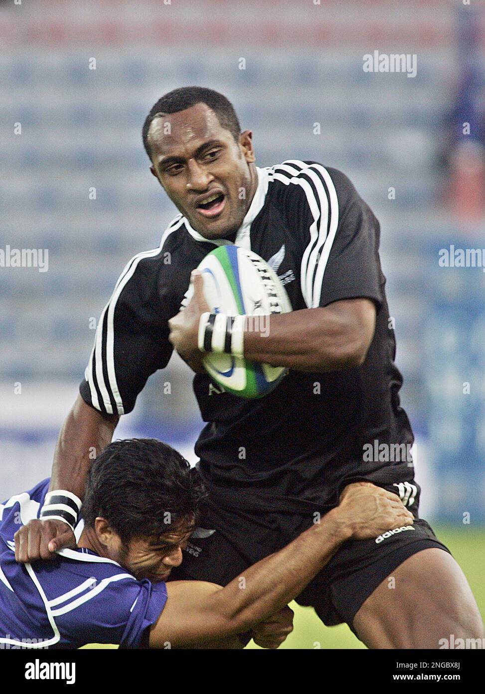 New Zealand's Joe Rokocoko, right, pushes away David Lemi from Samoa ...
