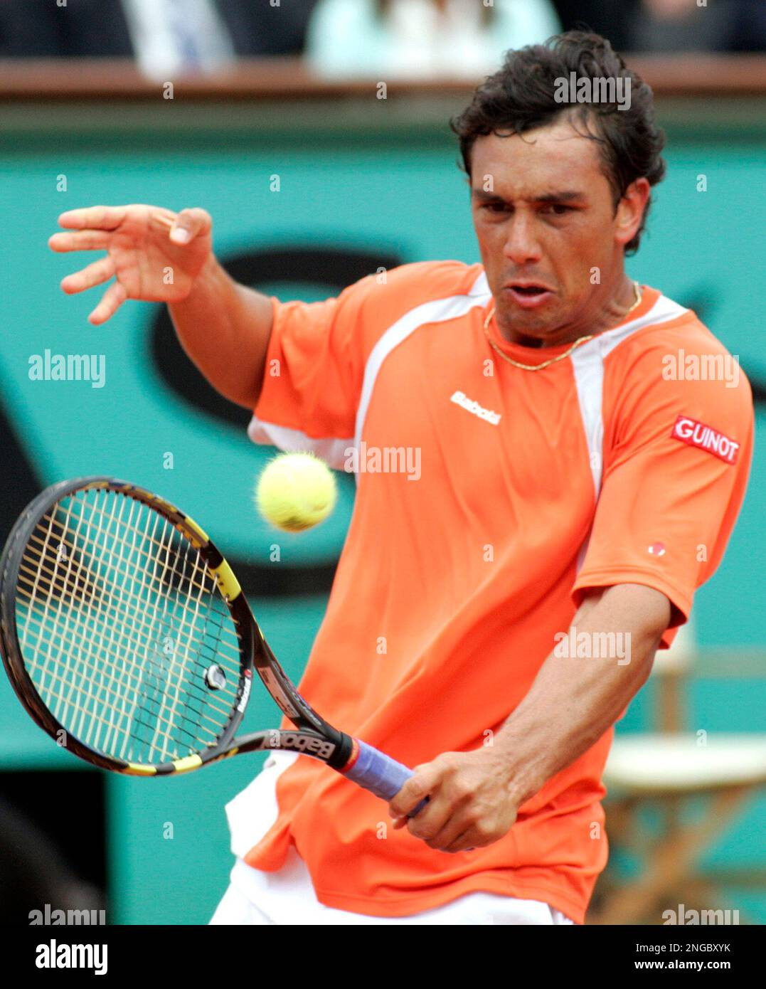 Argentina's Mariano Puerta hits a backhand to Spain's Rafael Nadal ...
