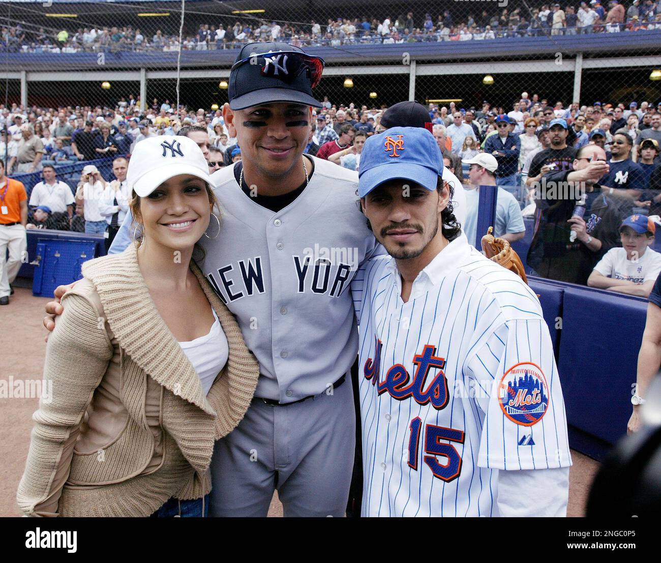New York Yankees third baseman Alex Rodriquez, center, stands with ...