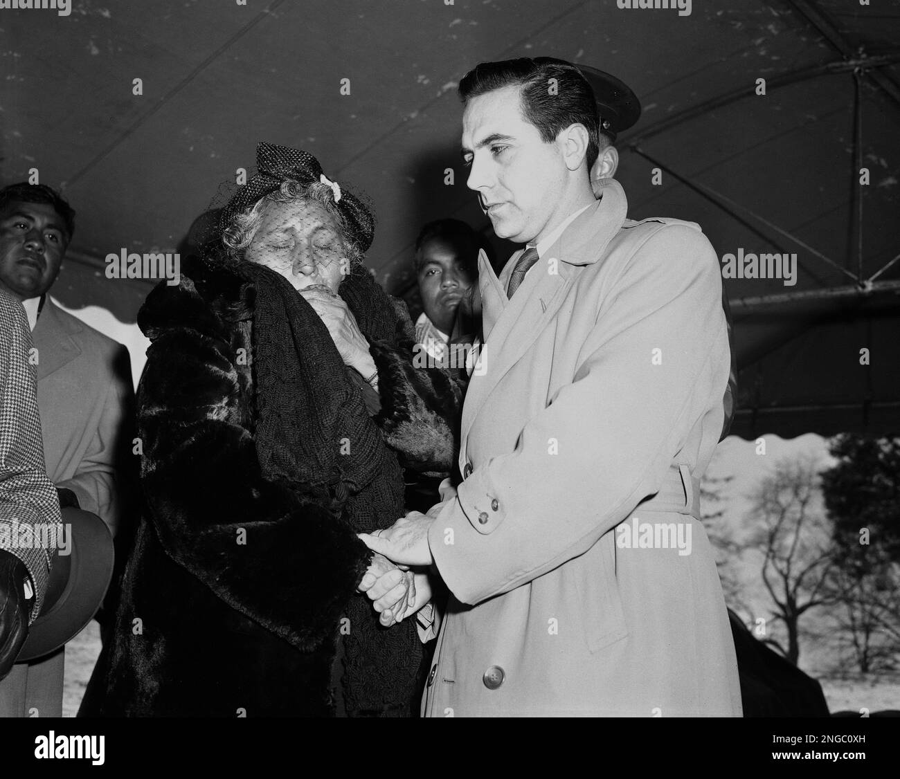 Rene Gagnon comforts Nancy Hayes after the burial of her son Ira, one ...