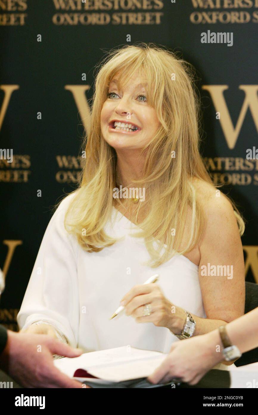 U.S. actress Goldie Hawn signs a copy of her book 'a lotus grows in the ...