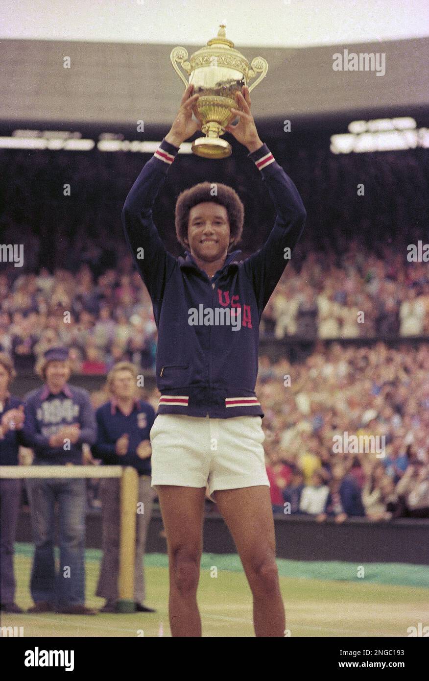 Arthur Ashe holds his Wimbledon trophy up after defeating fellow ...