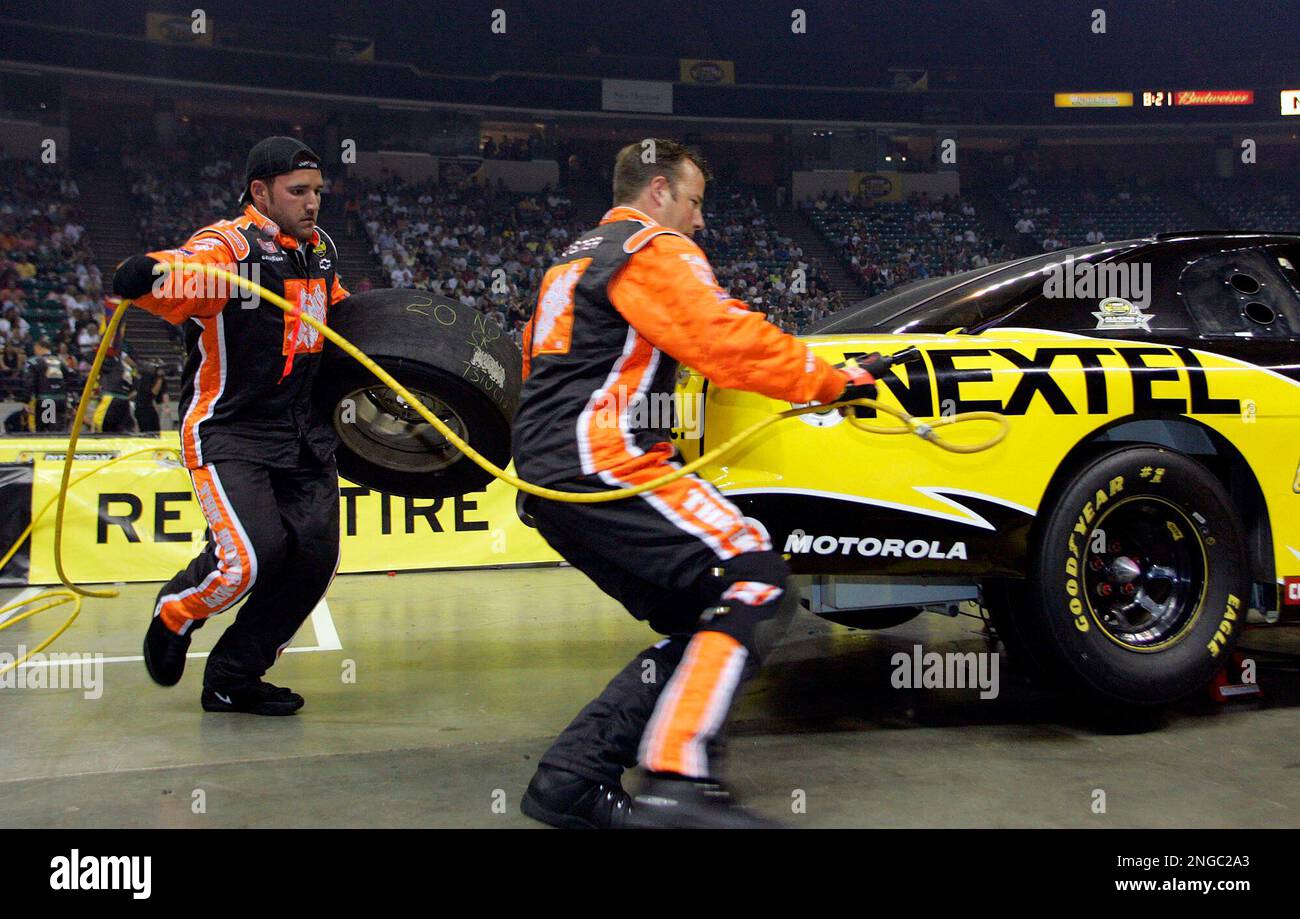 Rear tire carrier Jody Fortson, left, and rear tire changer Todd Foster ...