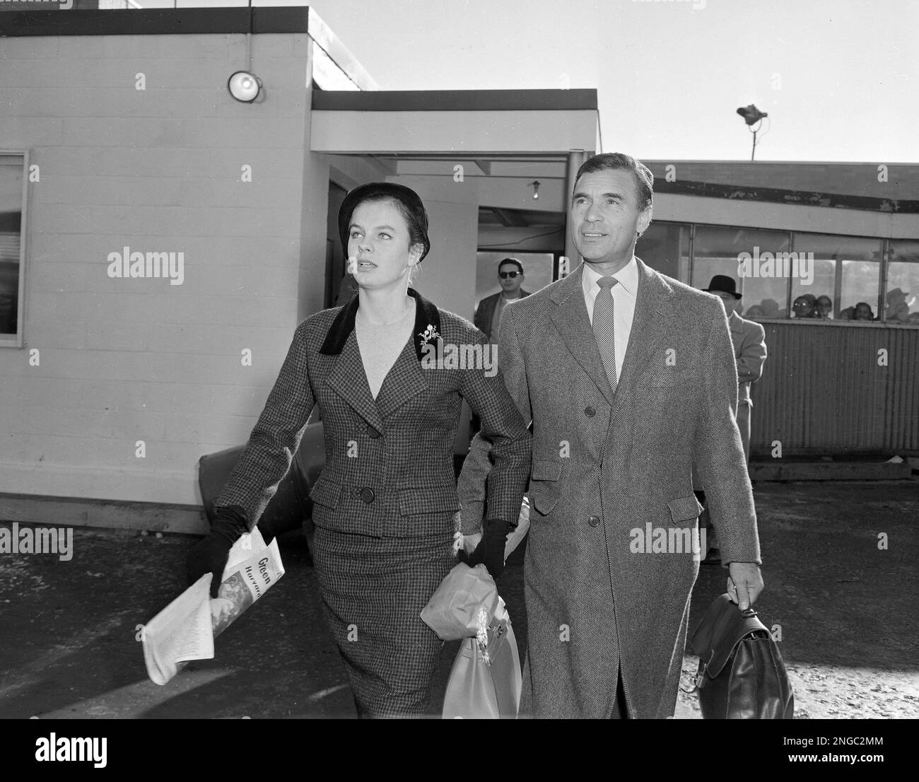 Porfirio Rubirosa and his wife, Odile Rodin, leave Idlewild Airport in ...