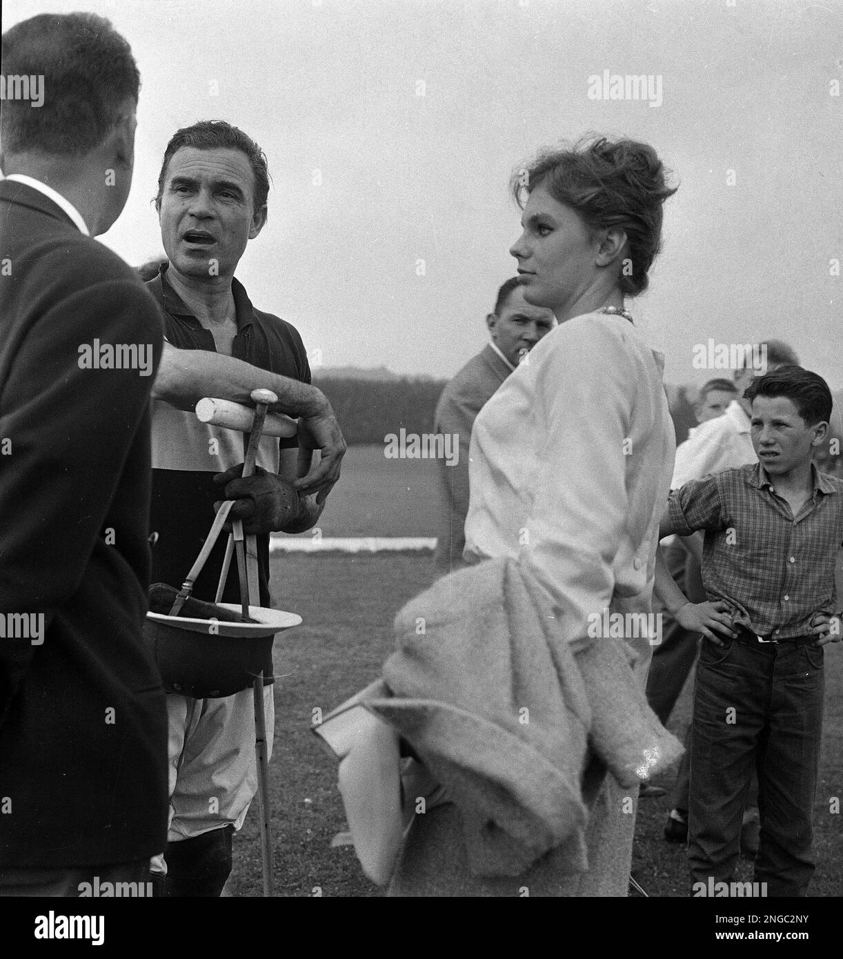 Dominican diplomat Porfirio Rubirosa chats after a polo match he played ...