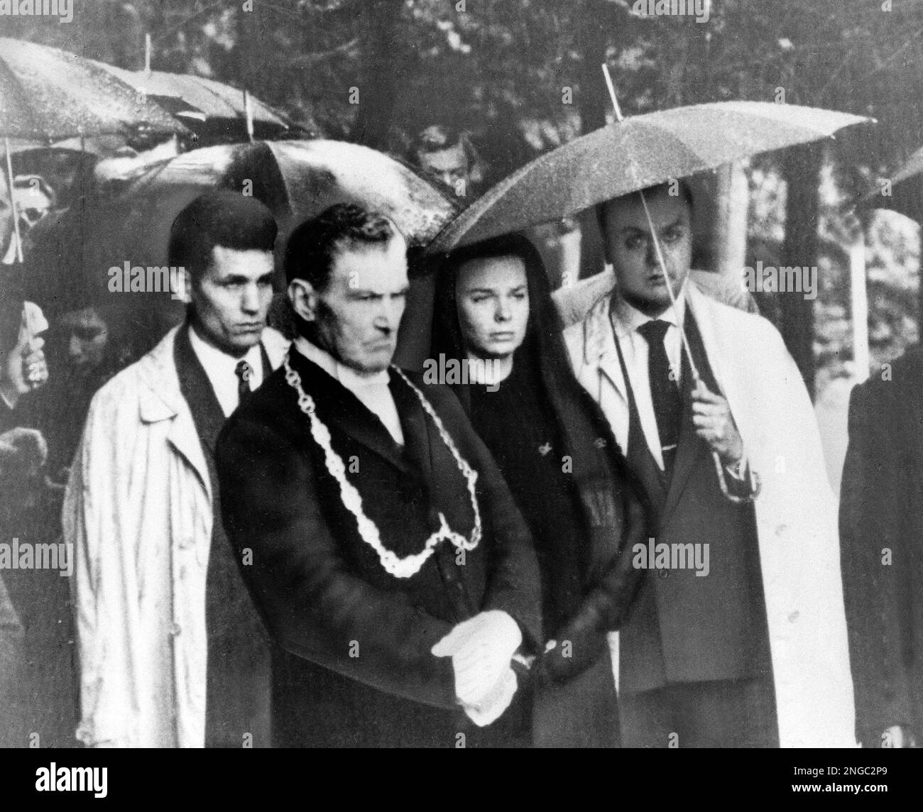 Odile Rodin, center, is shown during burial service for her husband ...