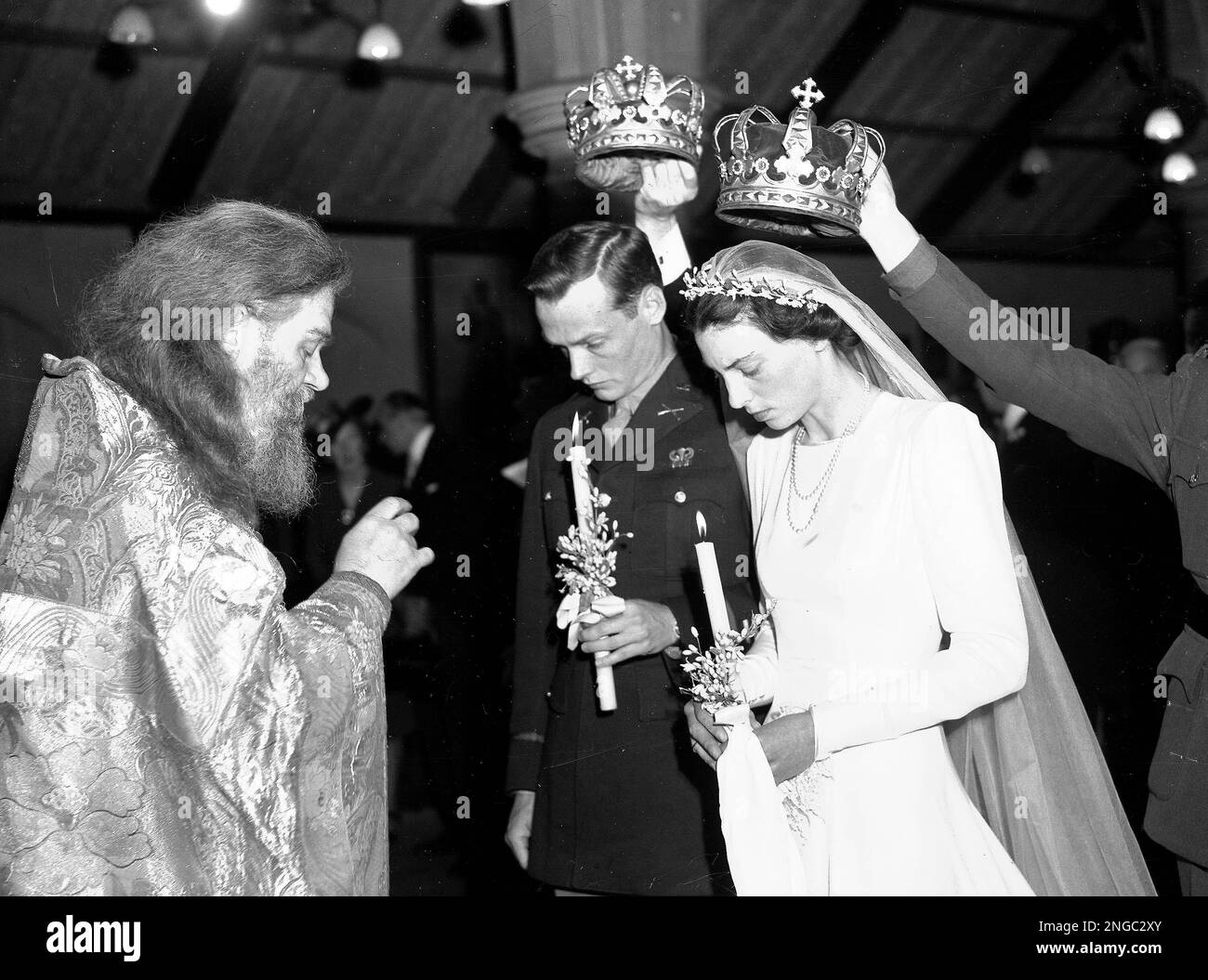 Ceremonial crowns are held over the heads of Russia's Princess Xenia ...