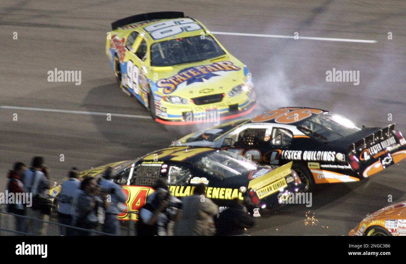 Michael Waltrip (99) spins out in turn two in front of Randy LaJoie (34 ...