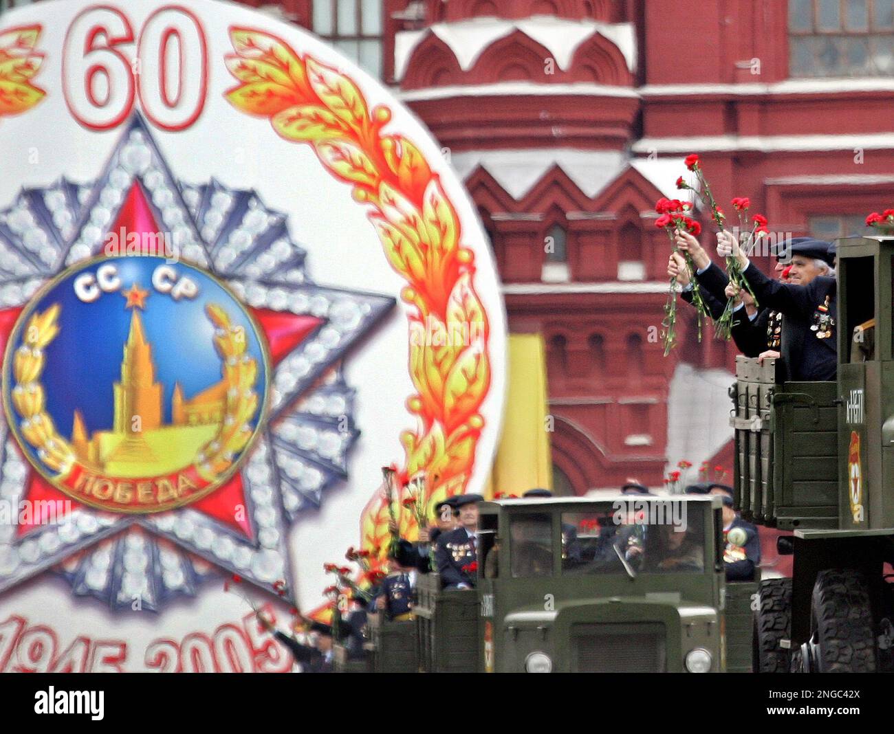 World War II veterans wave red roses during a parade on the Red Square ...