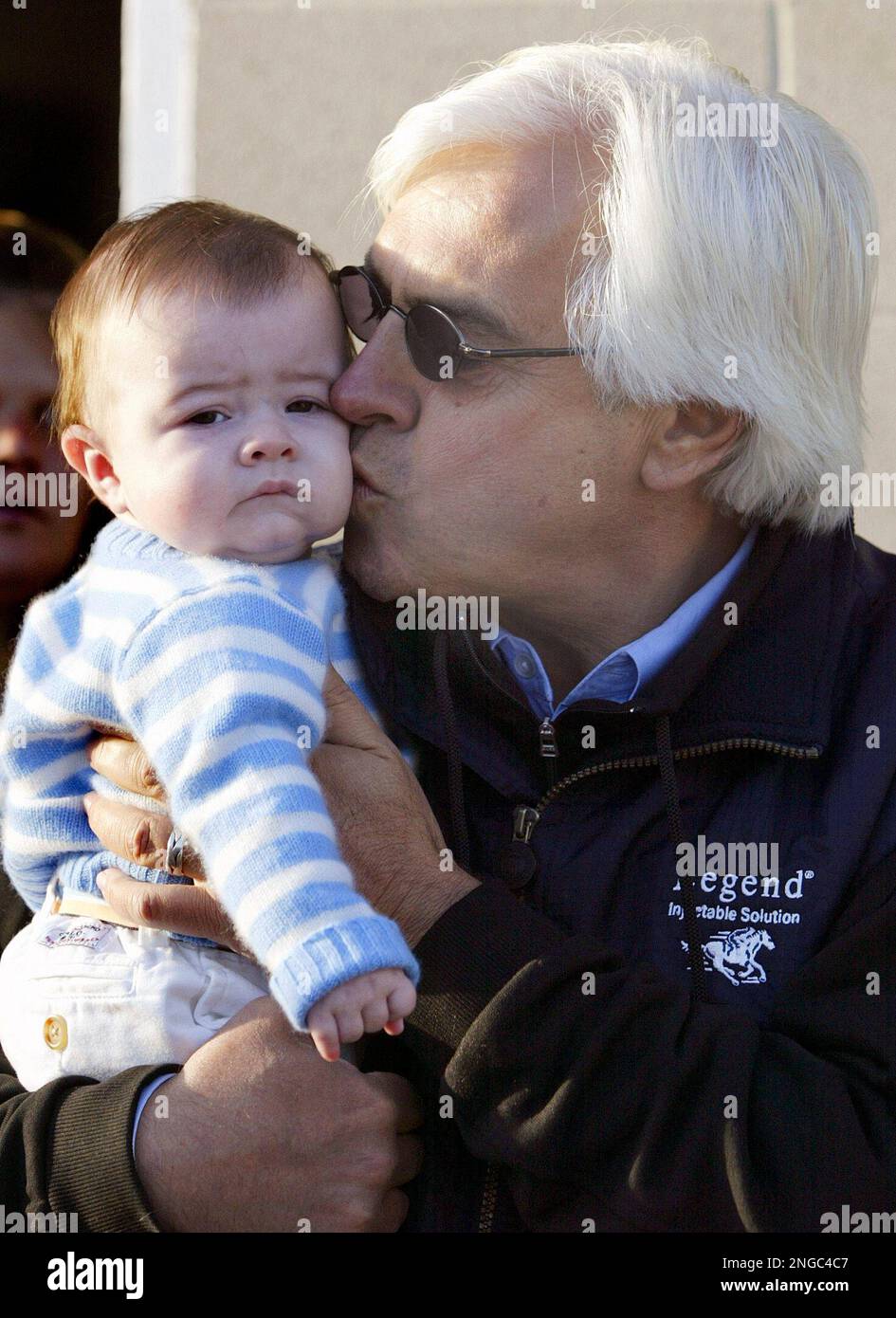 Trainer Bob Baffert kisses his four-month-old son Bode outside his barn ...