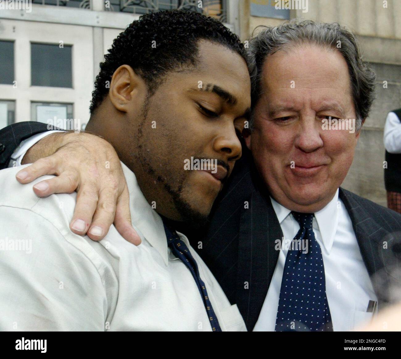 Former Nebraska football player Darren DeLone, left, gets a hug from ...