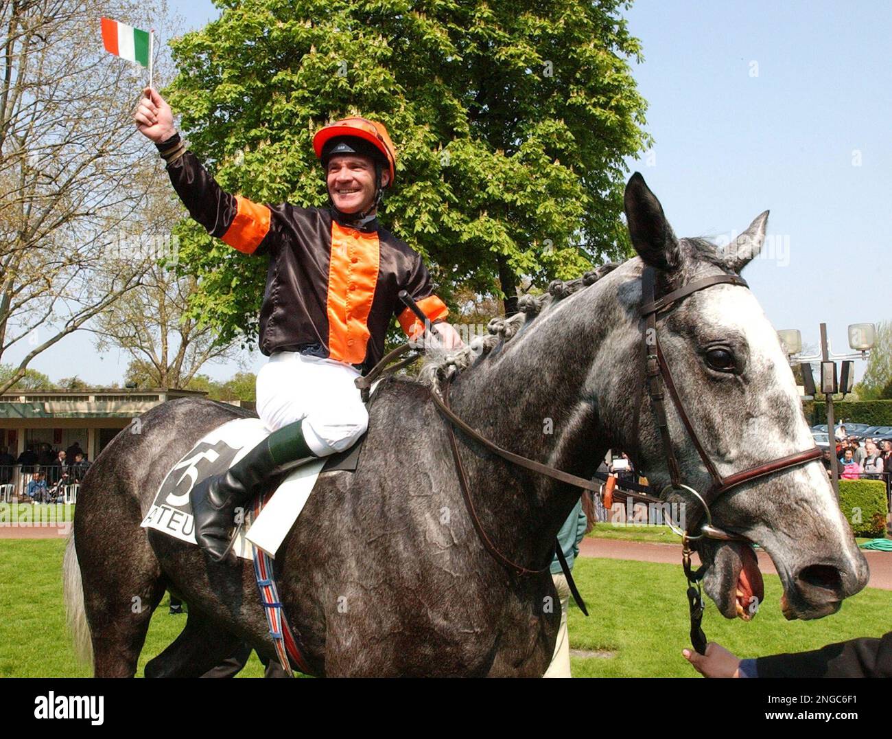 Irish jockey Dean Gallagher waves his national flag on horse Louping d ...