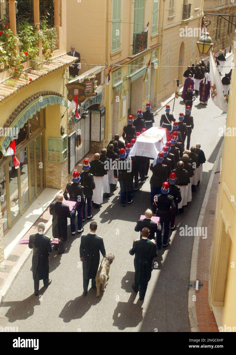 The coffin of Prince Rainier III is carried through a street during the ...