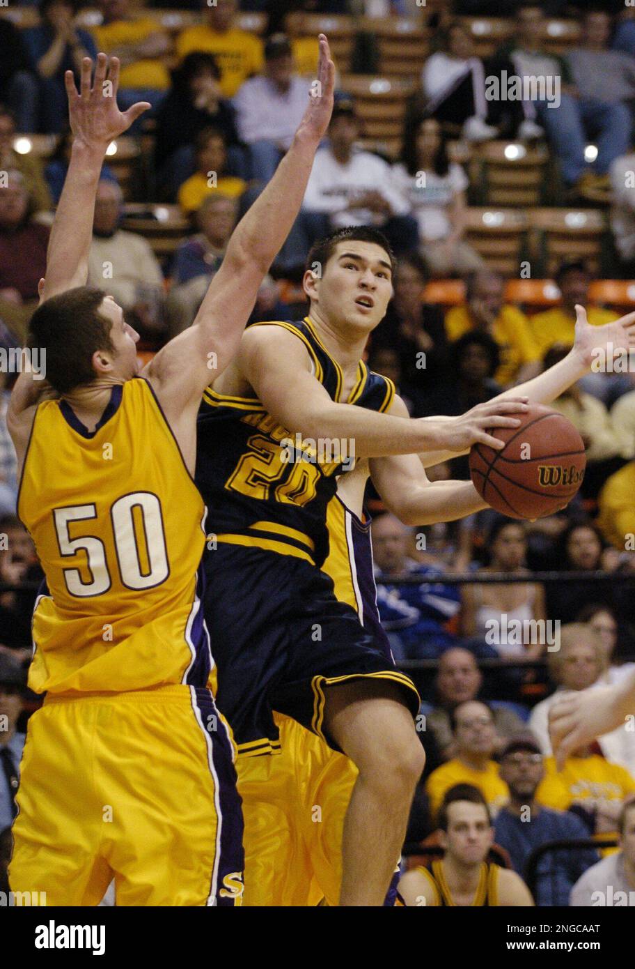 Rochester's Tim Brackney looks to pass around Stevens Point's Eric Maus ...