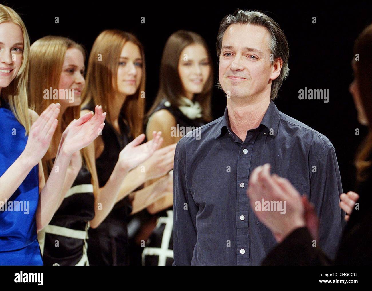 Fashion designer John Ribbe acknowledges applause at the end of his ...