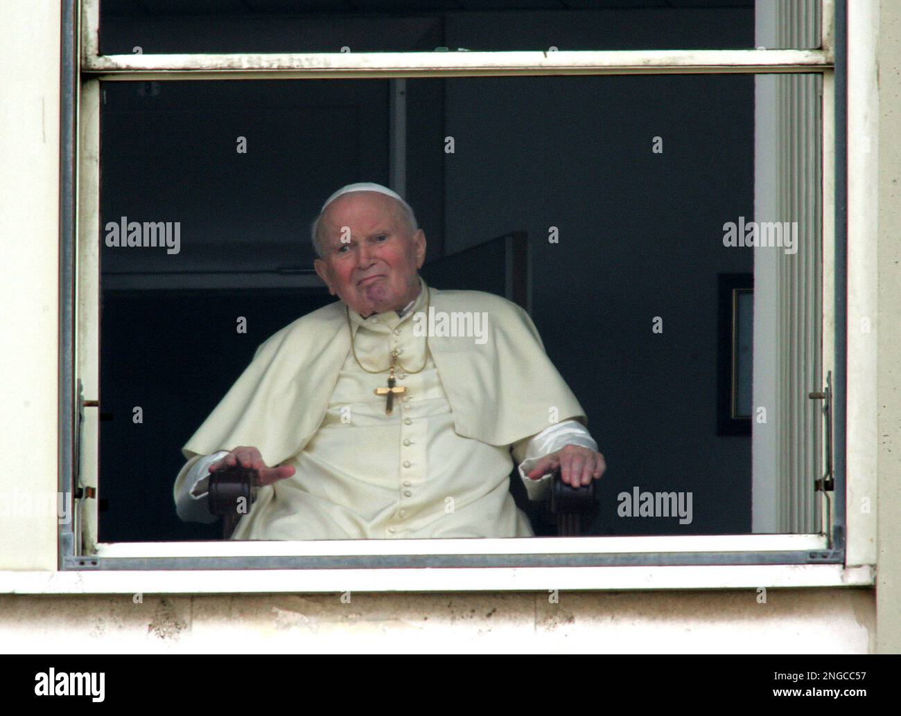 Pope John Paul II looks from behind his window as he appears at the end ...