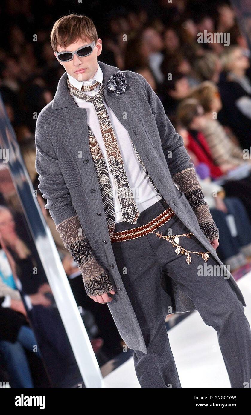 A male model sports an outfit designed by Karl Lagerfeld for Chanel's ...