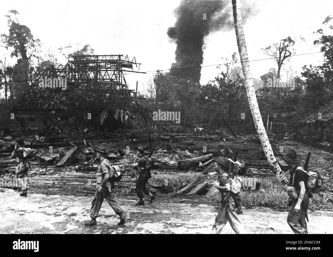 Australian troops march along a road on Tarakan Island, off the coast ...