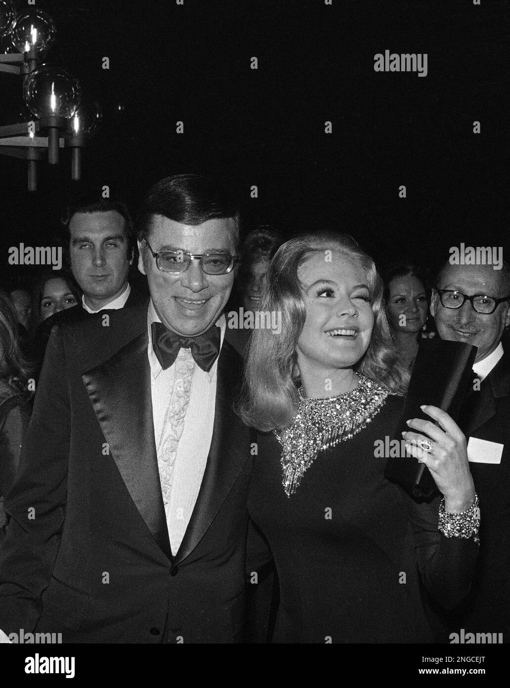 Producer Ross Hunter, left, arrives with actress Sandra Dee, winking ...