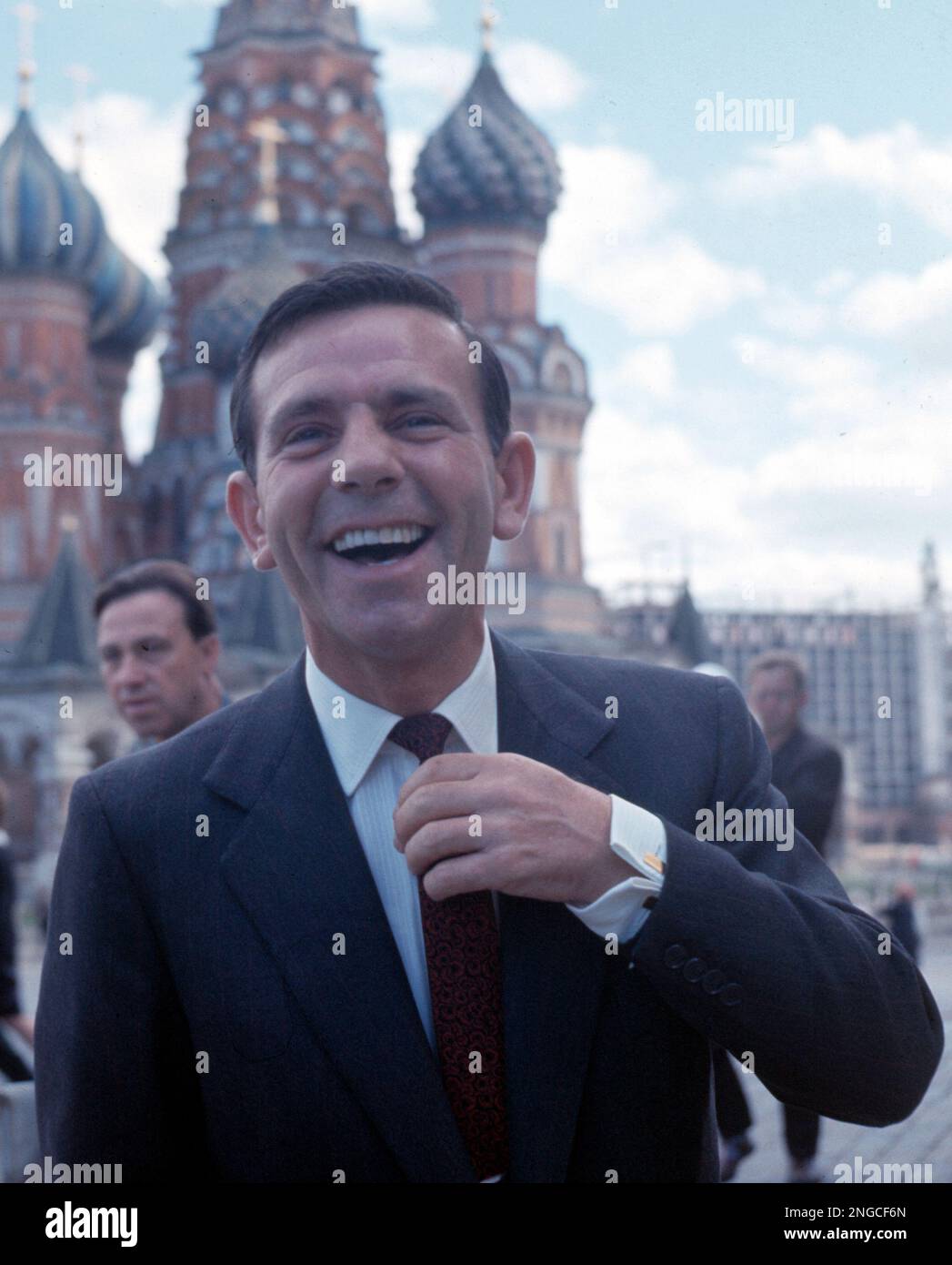British actor and comedian Norman Wisdom laughs with the photographer ...