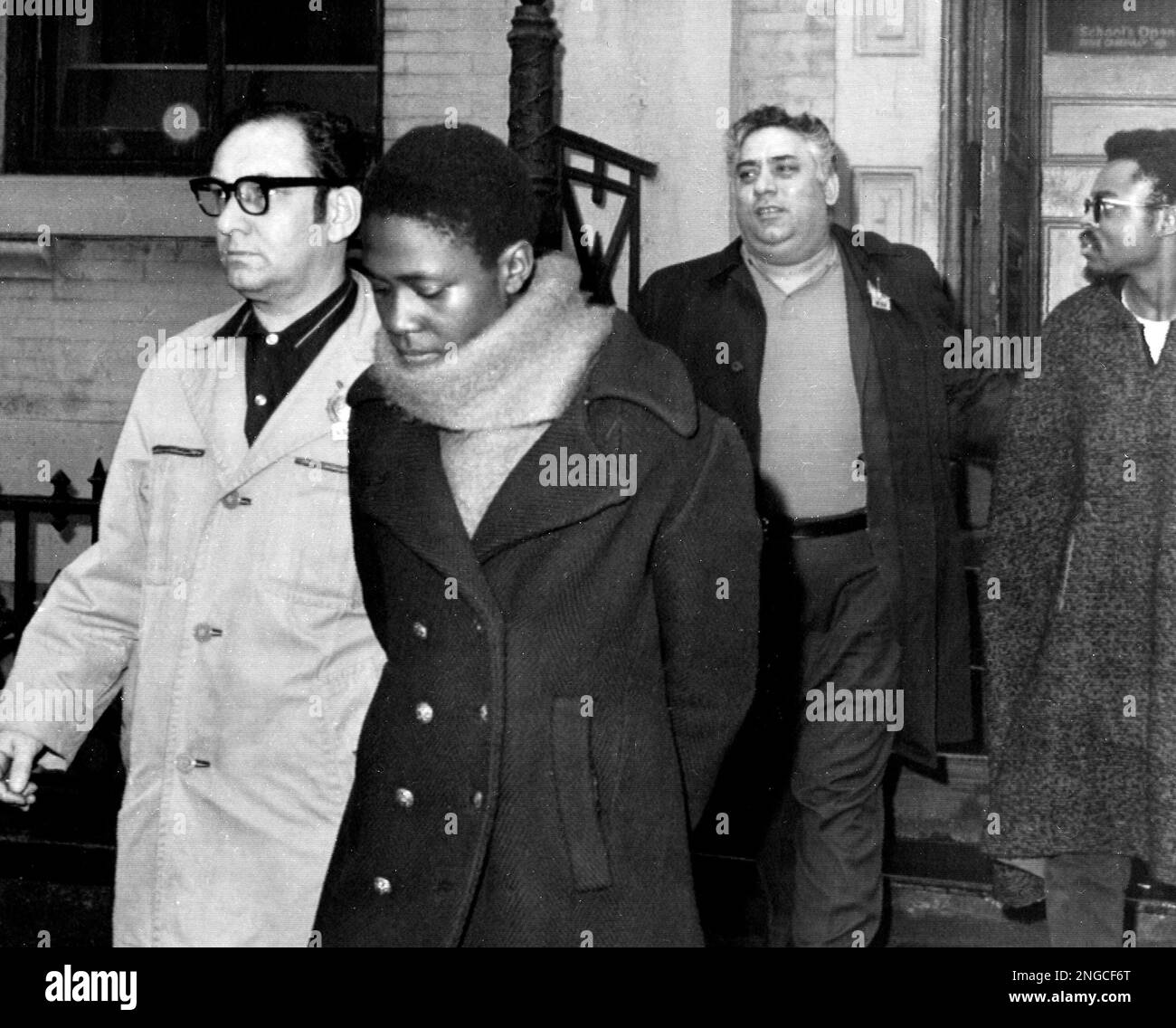 Lumumba Abdul Shakur, right, and his wife Afeni, centre, are escorted ...