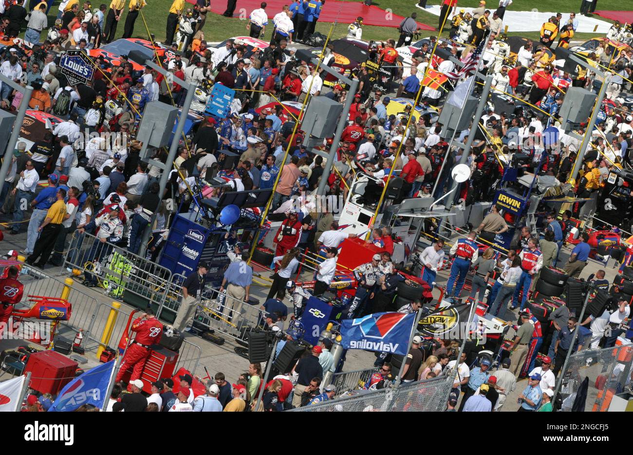 The pits are a crowded with fans and pit crew members prior to the ...