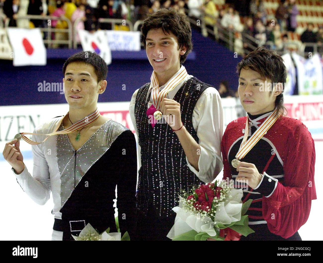 Evan Lysacek of the U.S., center, shows off his gold medal, accompanied ...