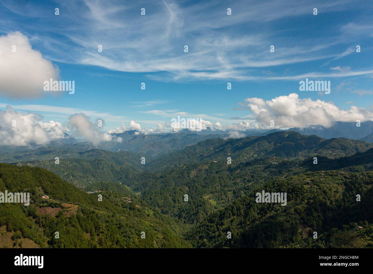 Aerial view of Mountains covered rainforest, trees and blue sky with ...