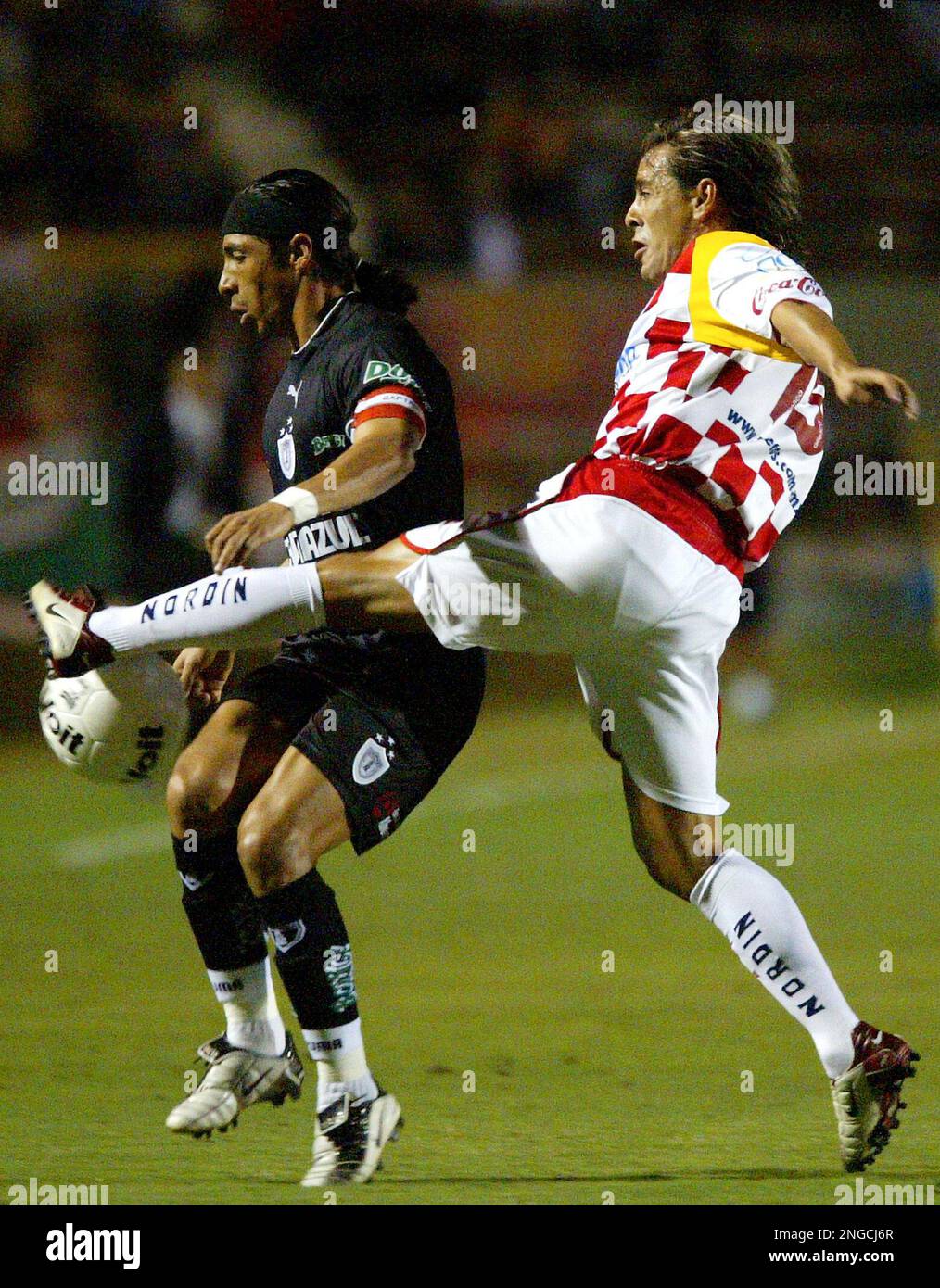 Tecos player Alejandro Villalobos, right, fights for the ball against ...