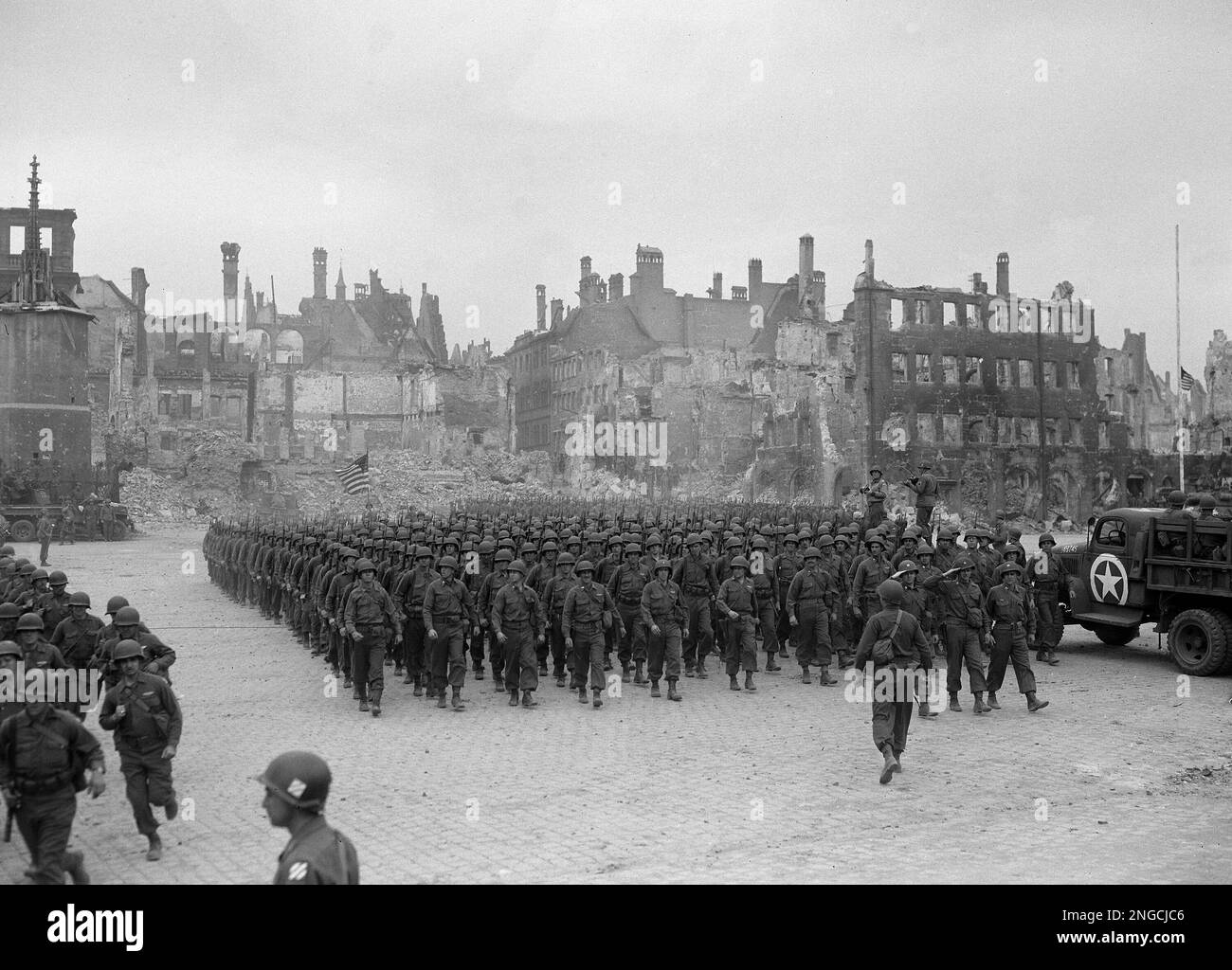 Troops of the 7th U.S. Army march past the reviewing stand at Adolf ...