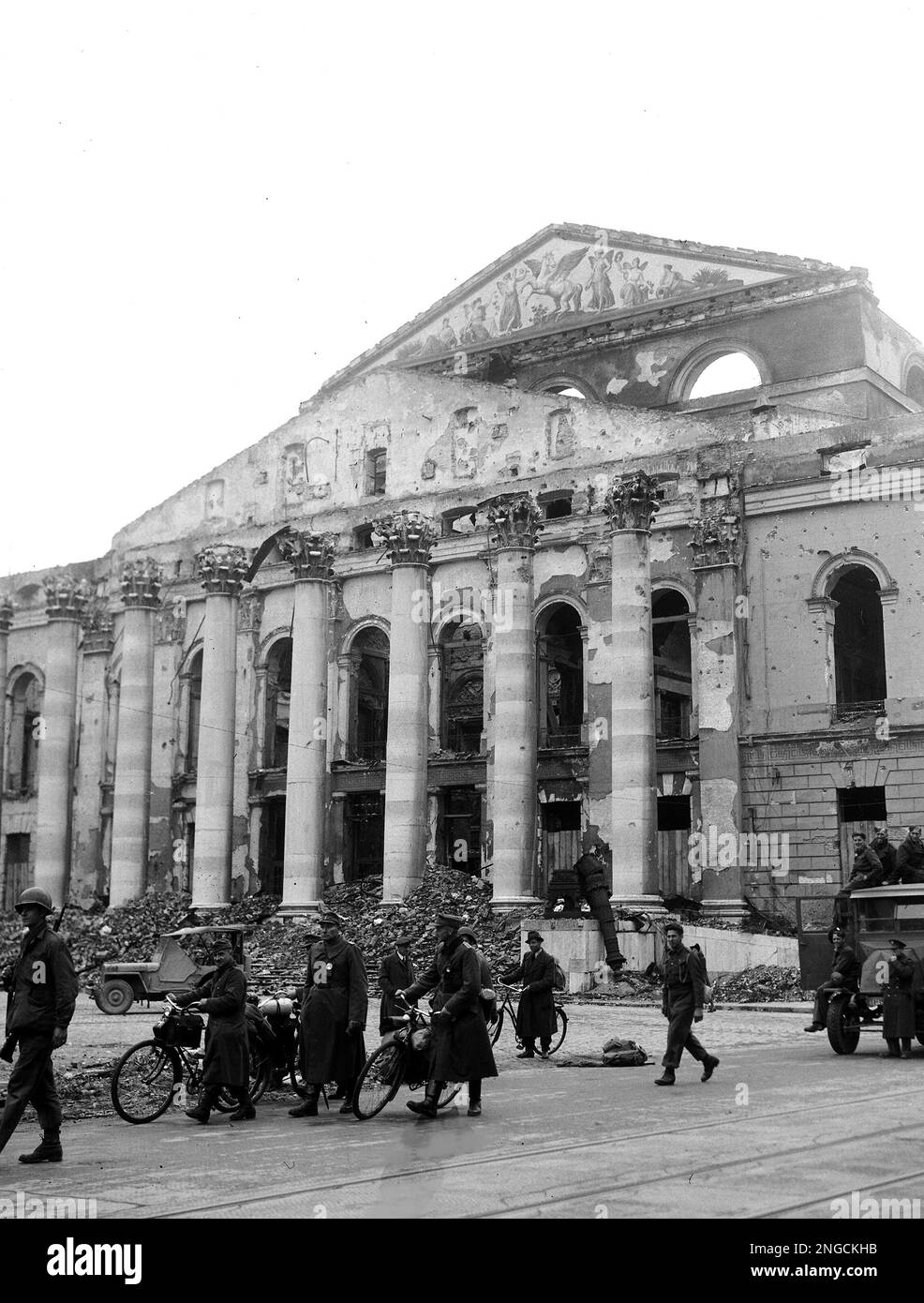 German prisoners of war push their bicycles past the ruins of the Great ...