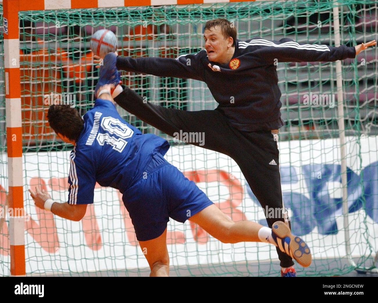Russian goalkeeper Denis Tarassov stretches out to stop the ball shot ...