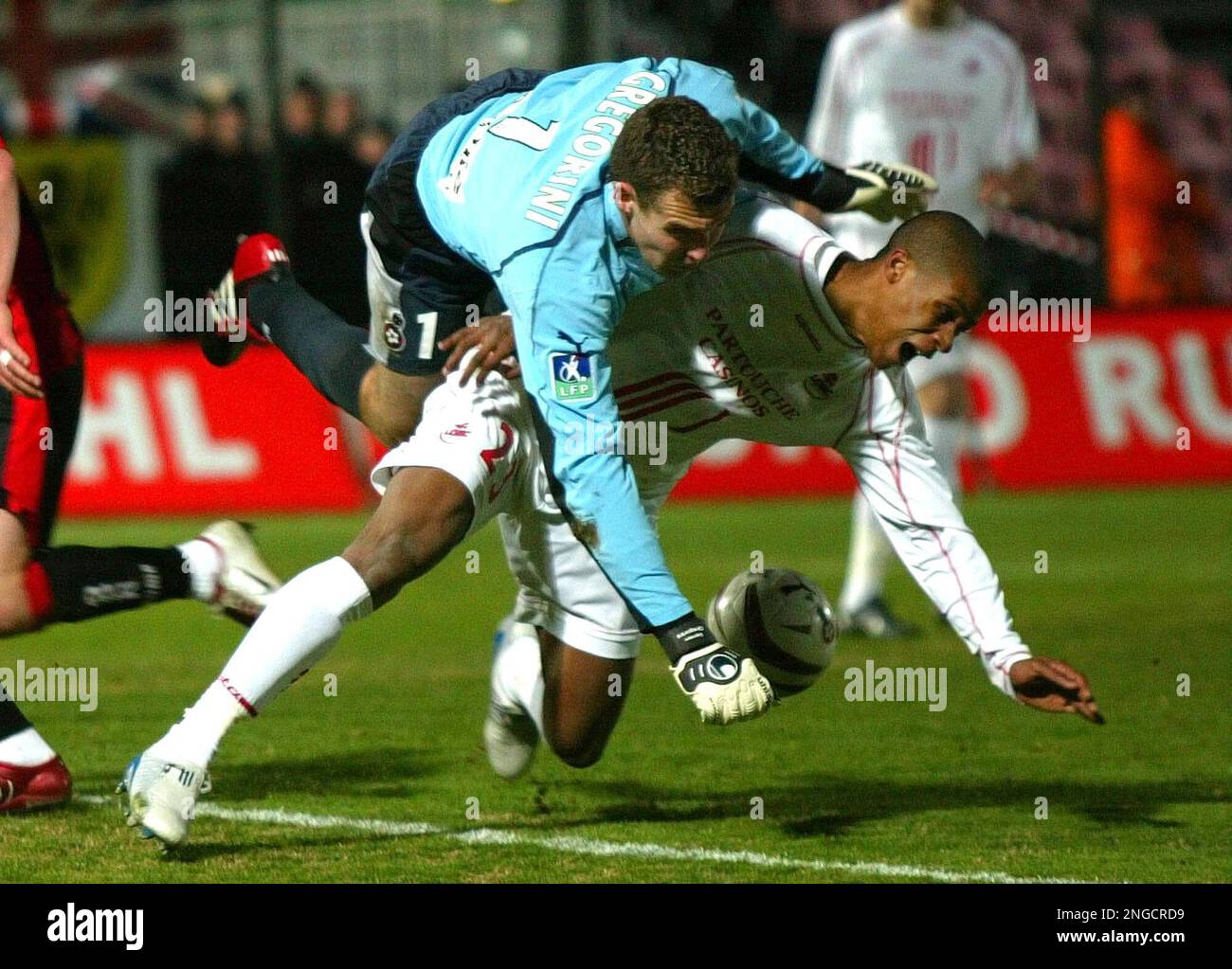 OGC Nice goalkeeper Damien Gregorini, top, fights for the ball with ...
