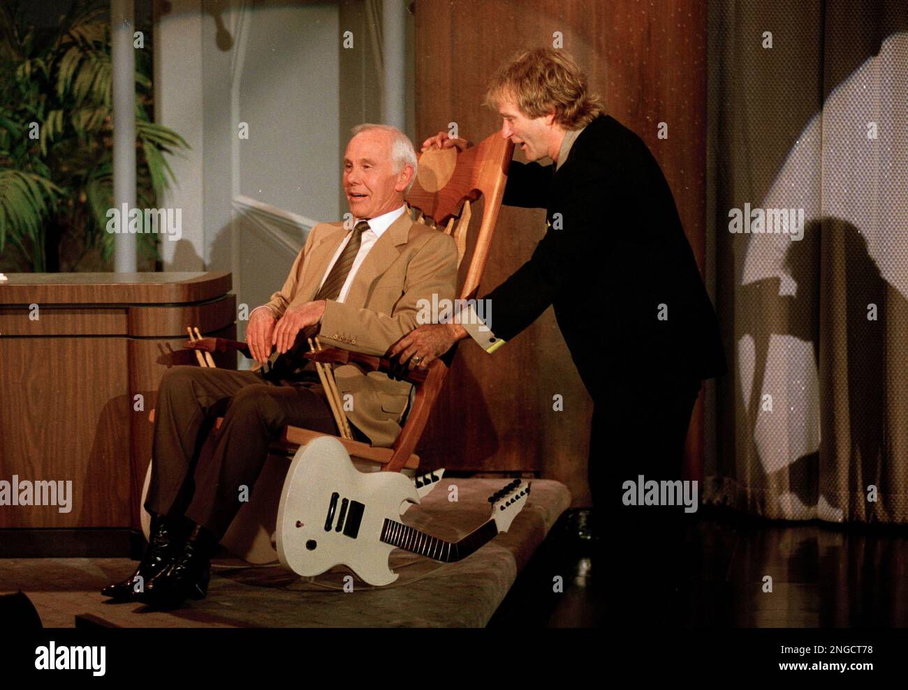 Talk show host Johnny Carson, left, sits in a rocking chair presented ...