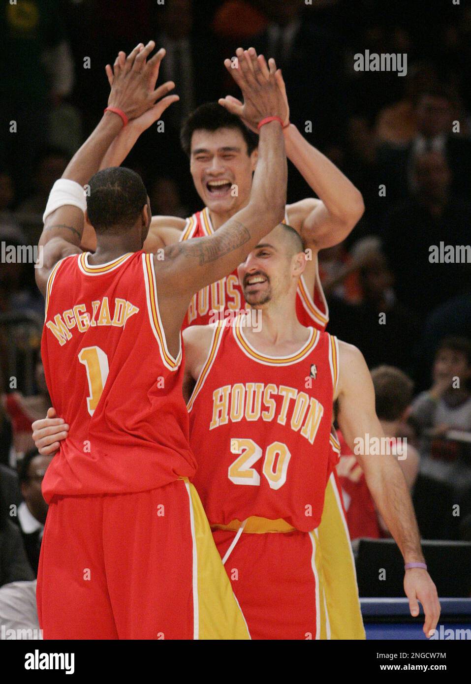Houston Rockets' Tracy McGrady, Jon Barry and Yao Ming celebrate after ...