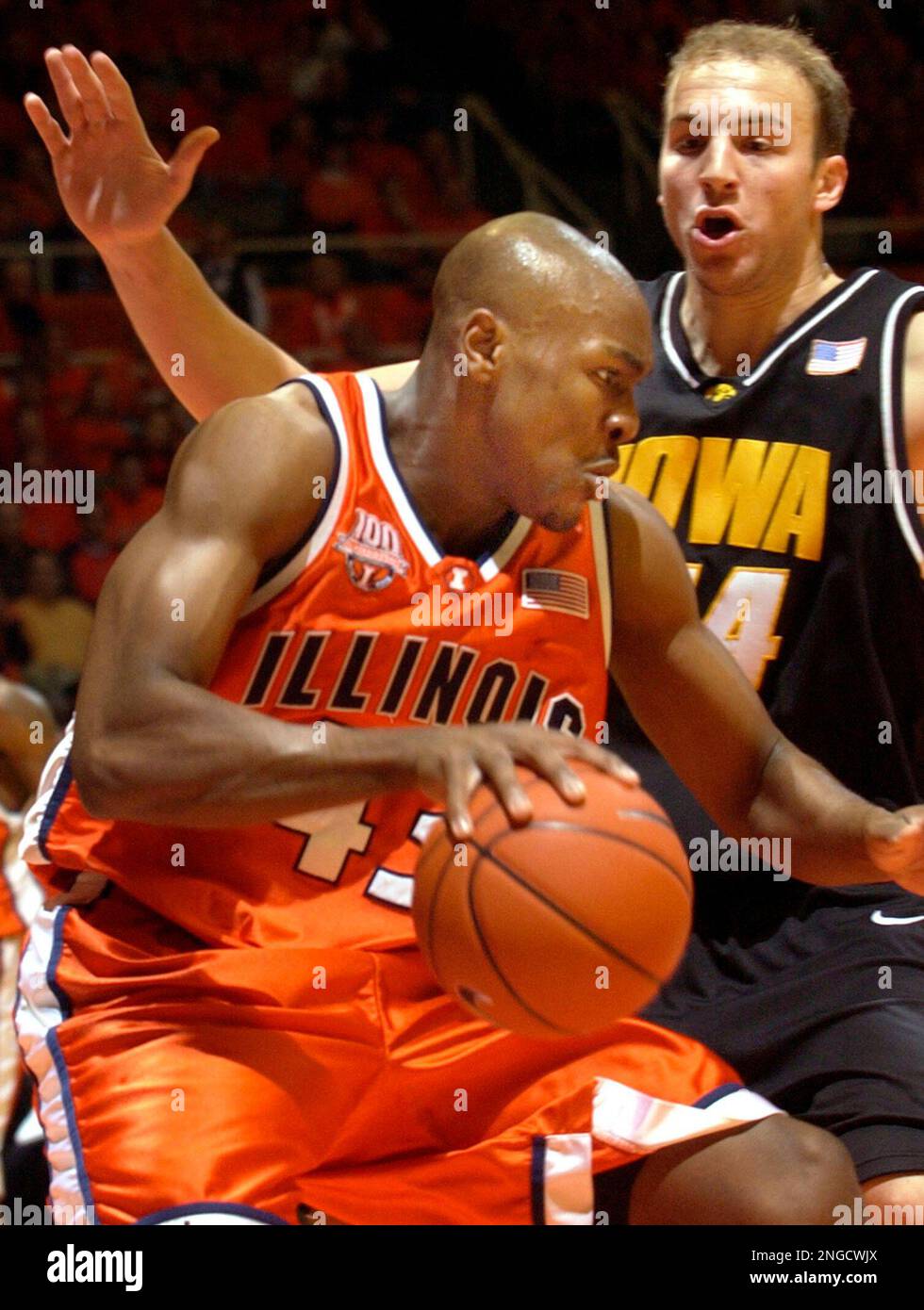 Illinois' Roger Powell drives into Iowa's Greg Brunner in the first ...