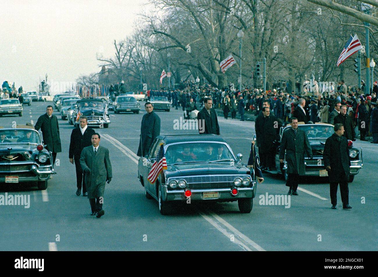 The motorcade carrying President-elect Lyndon B. Johnson and his wife ...