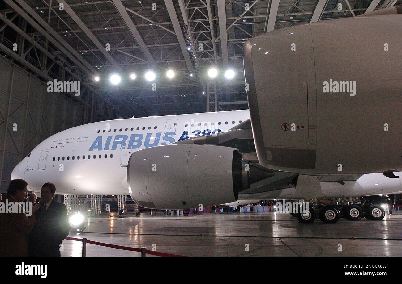 People stand near the new Airbus A380 after its unveiling ceremony ...
