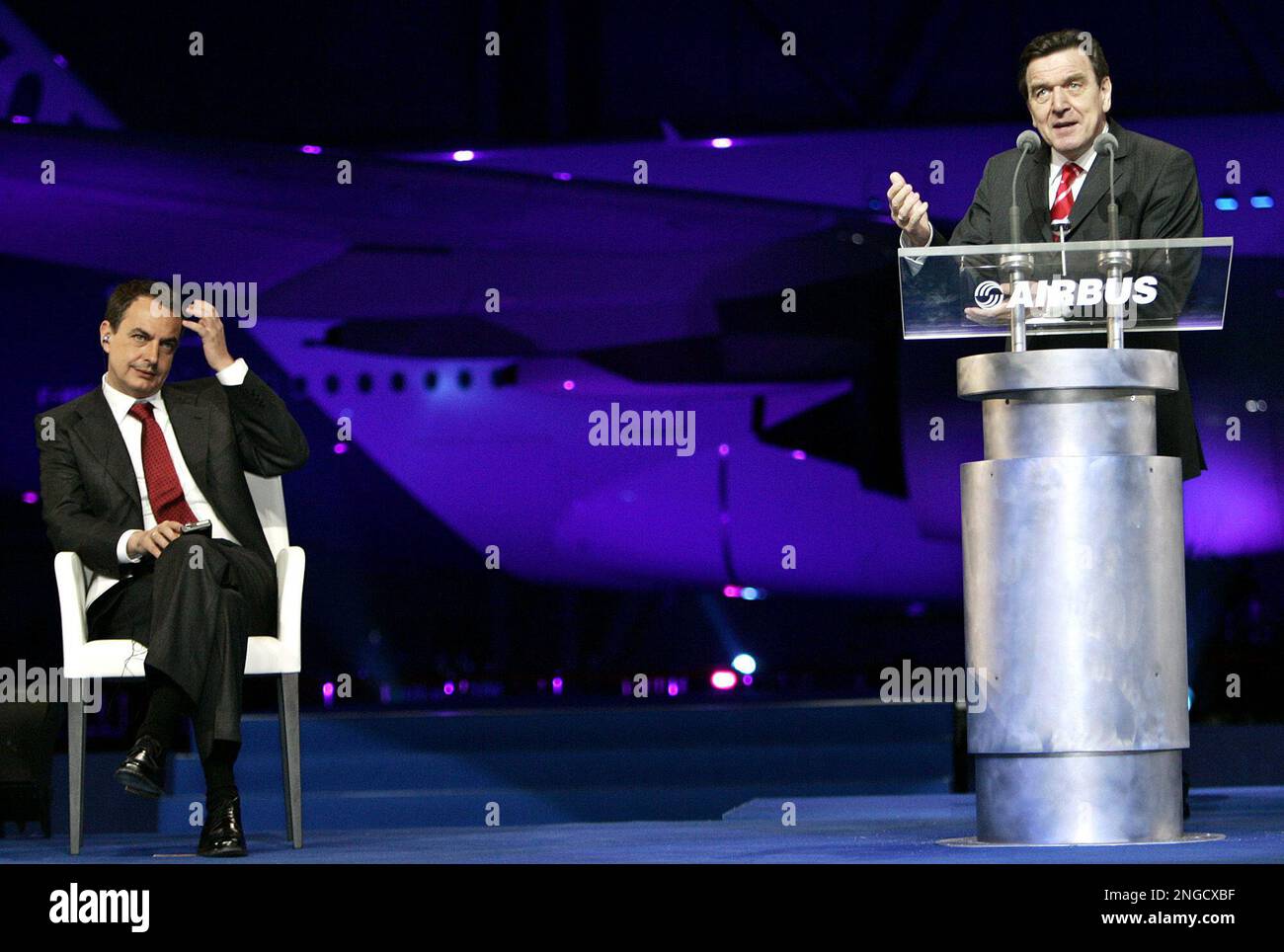 German Chancellor Gerhard Schroeder, right, delivers his speech while ...
