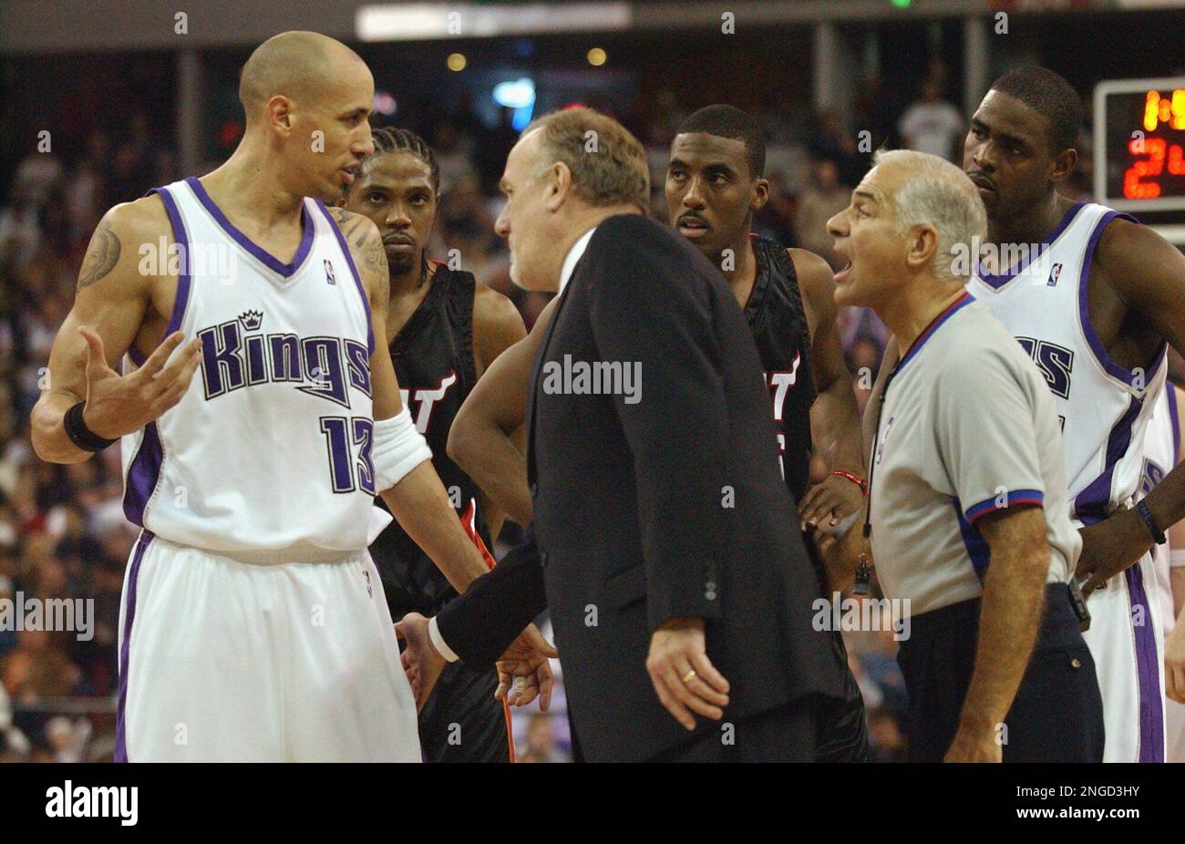 Sacramento Kings coach Rick Adelman, center, steps between Kings guard ...
