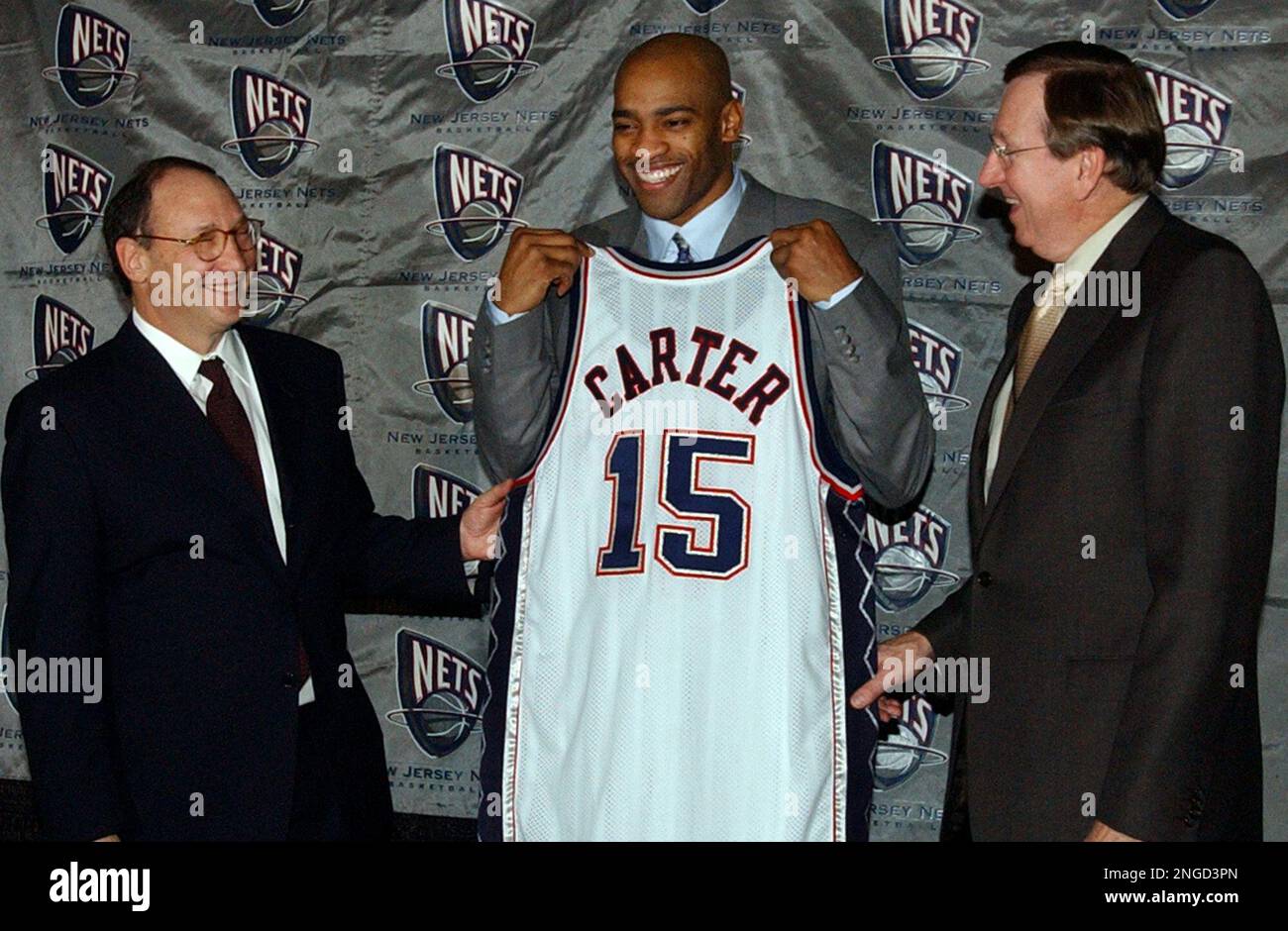 New Jersey Nets' Vince Carter holds up his new jersey as principal ...