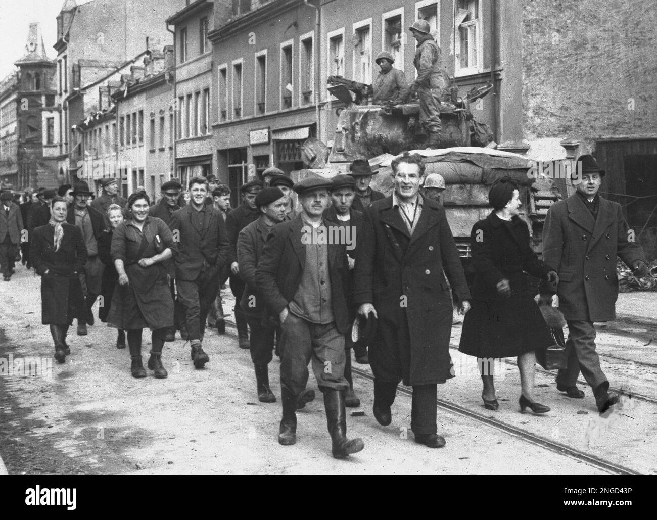 Civilians carry their belongings to an assembly point in Trier, Germany ...