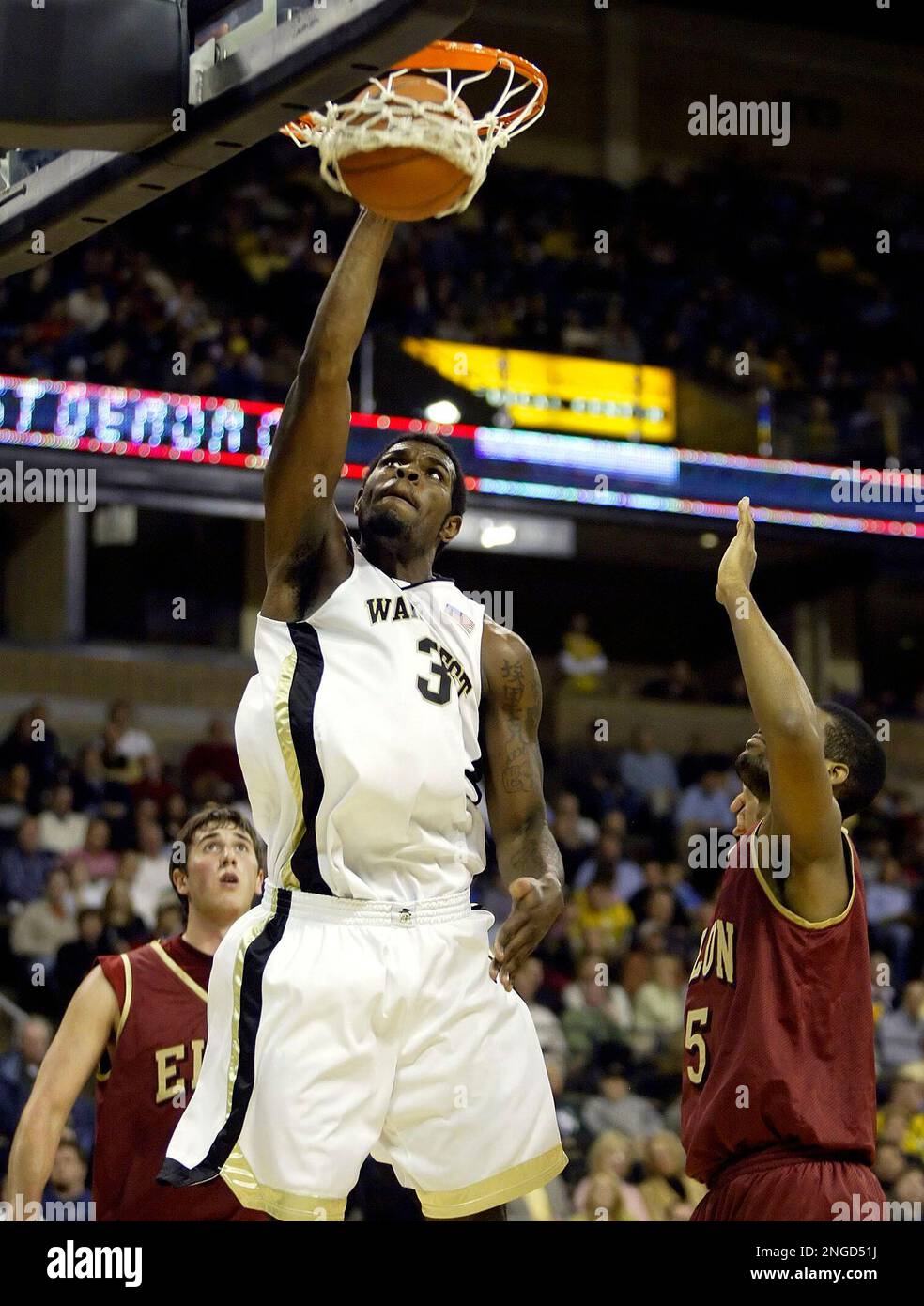 Wake Forest's Eric Williams (31) dunks as Elon players Rasmi Gamble (5 ...