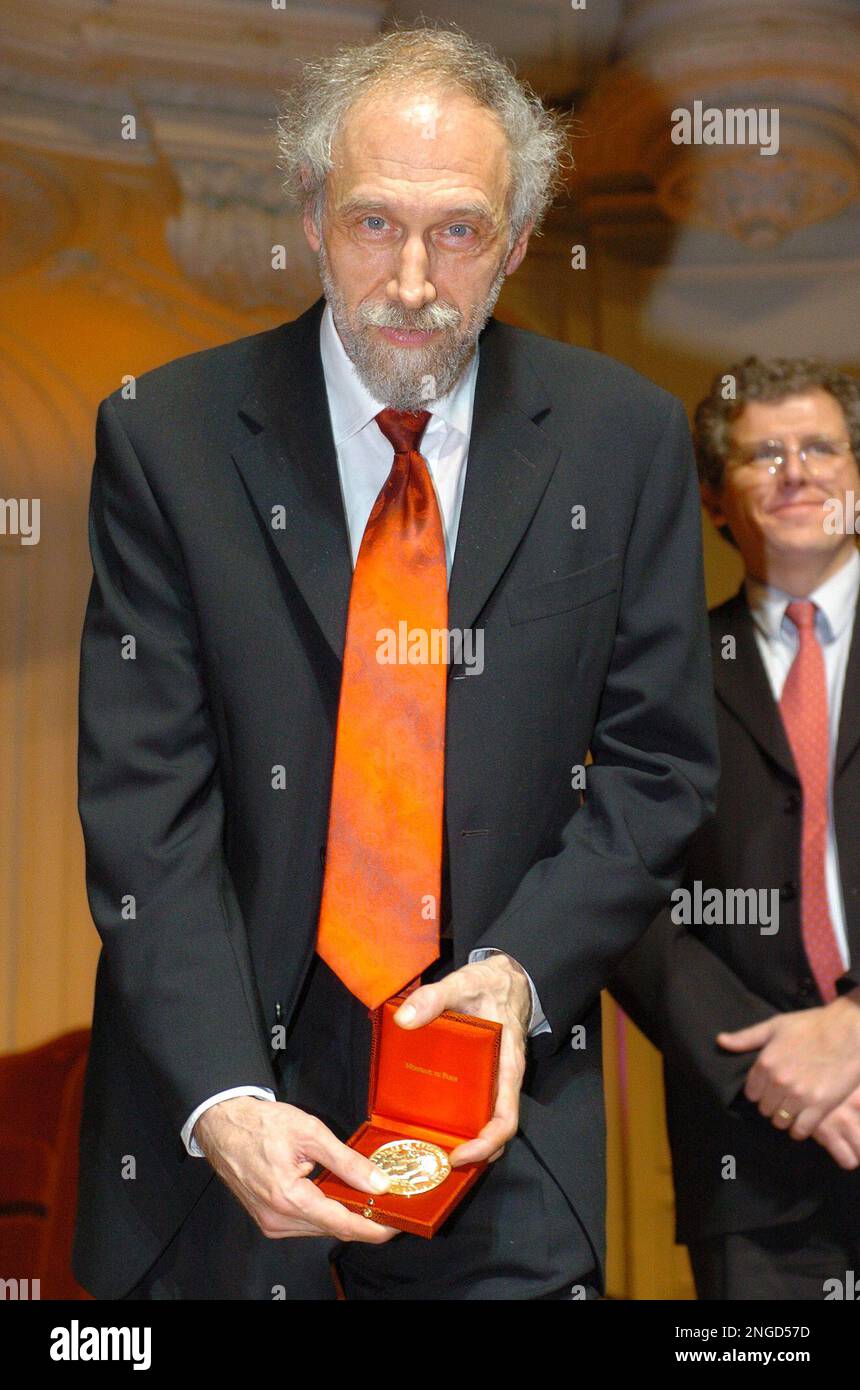 French mathematician Alain Connes shows the golden medal he was awarded ...