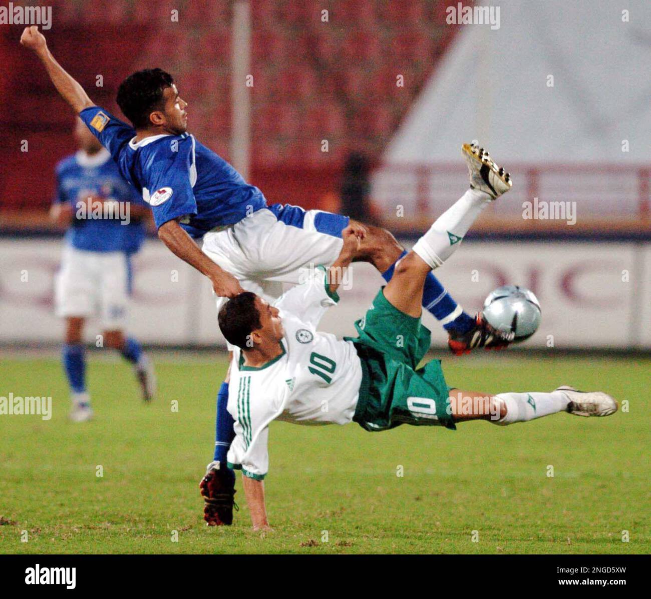 Kuwait's Ahmed Al Shamri, left, battles the ball from the Saudi Arabia ...