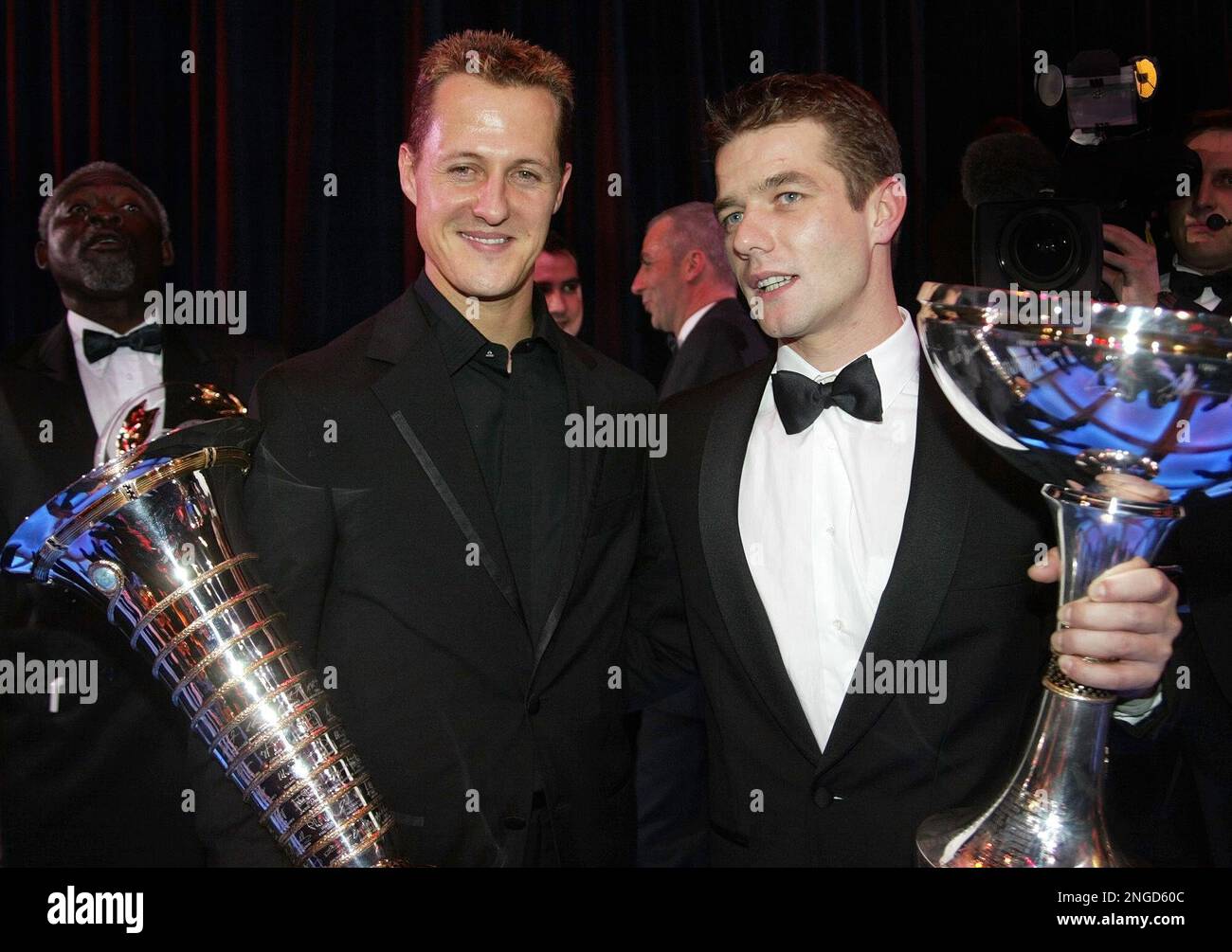 German Formula One driver Michael Schumacher ,left, holding his FIA ...