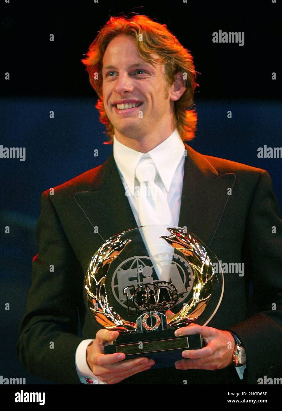 British Formula One driver Jenson Button holds the trophy for the third ...