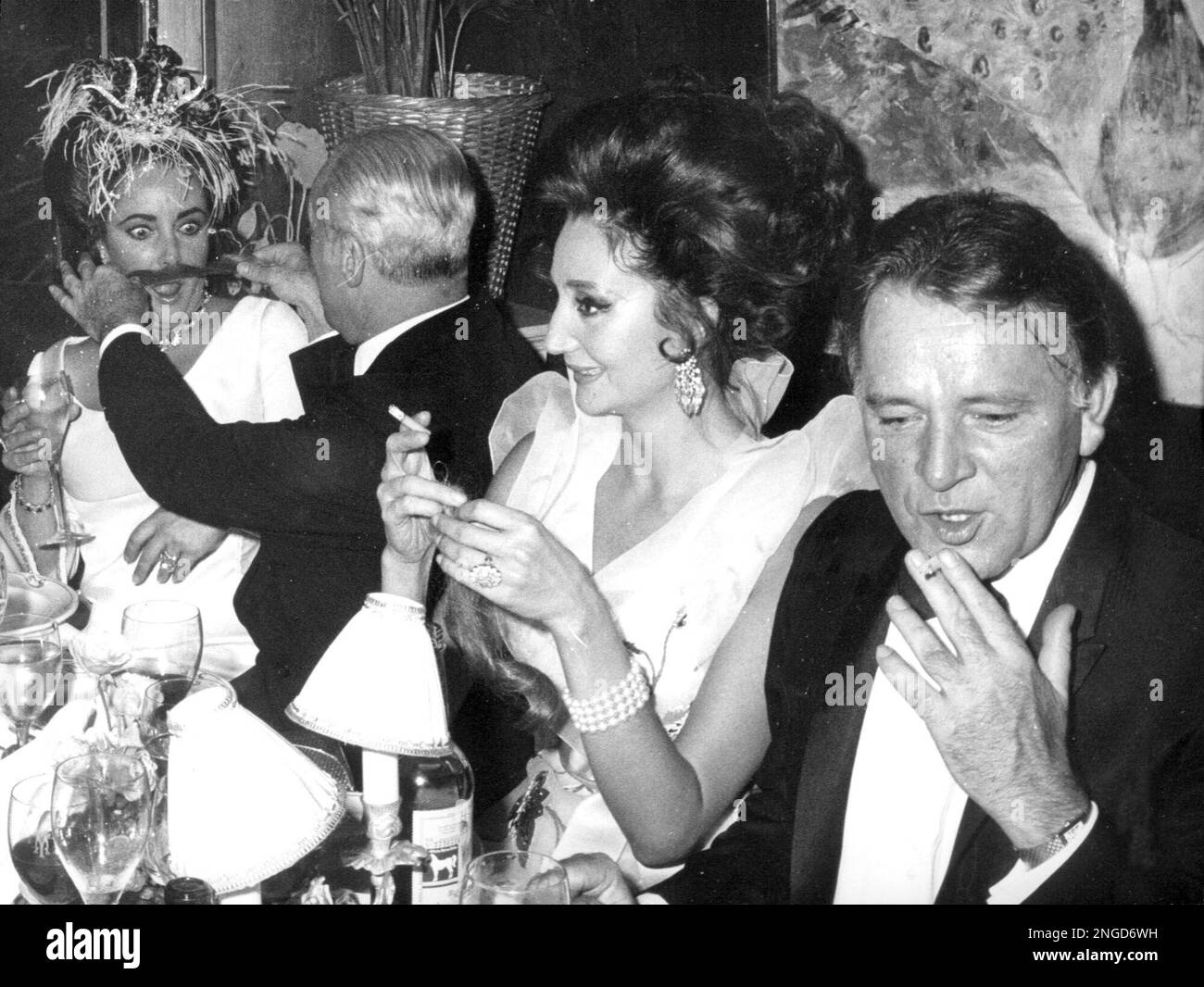 Elizabeth Taylor, far left, gets a moustache fixed by Baron de ...