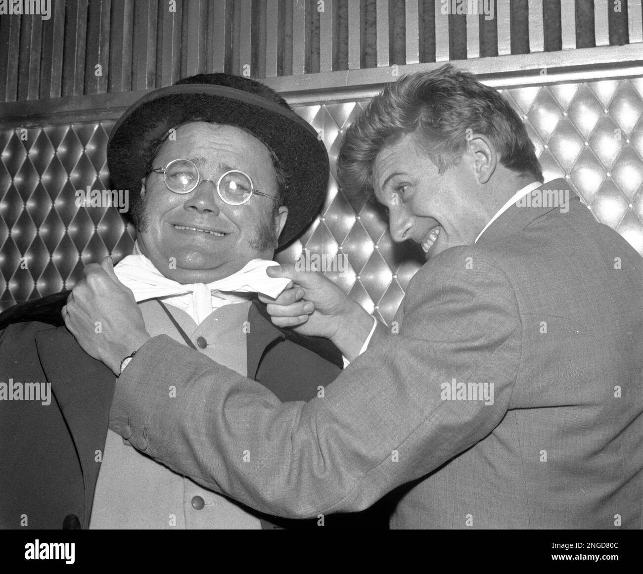 British actor and singer Tommy Steele, right, helps to tighten the ...